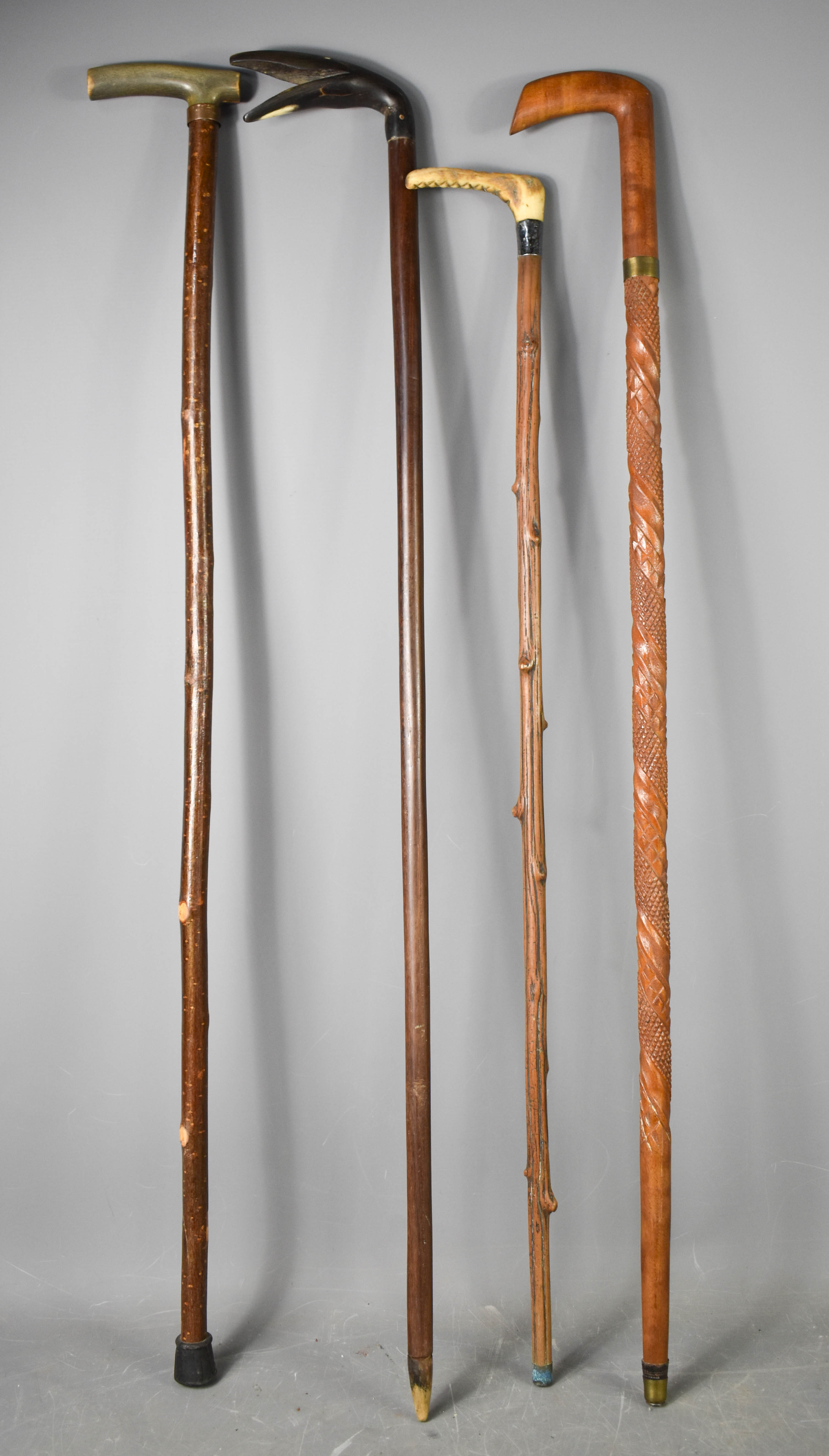 Lot 211 - Four vintage walking canes, three with horn