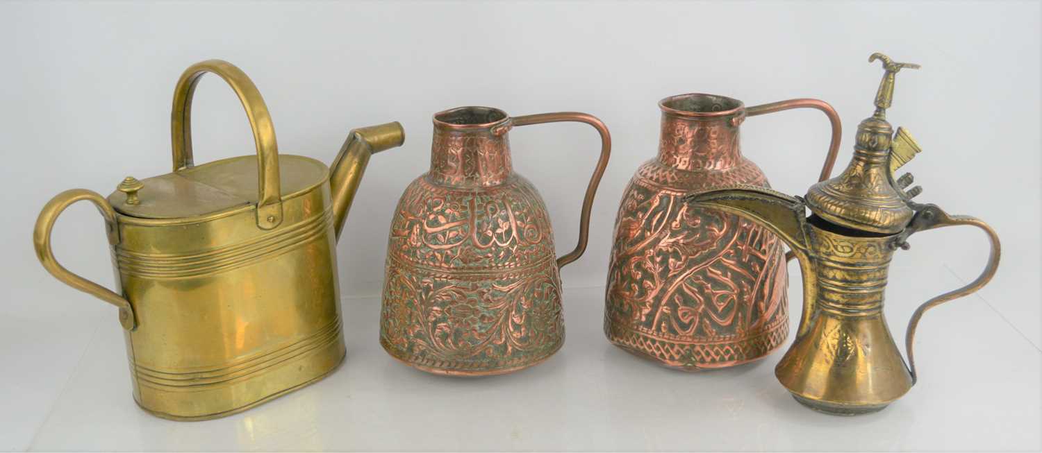 Lot 497 - A Three Islamic brass and copper jugs