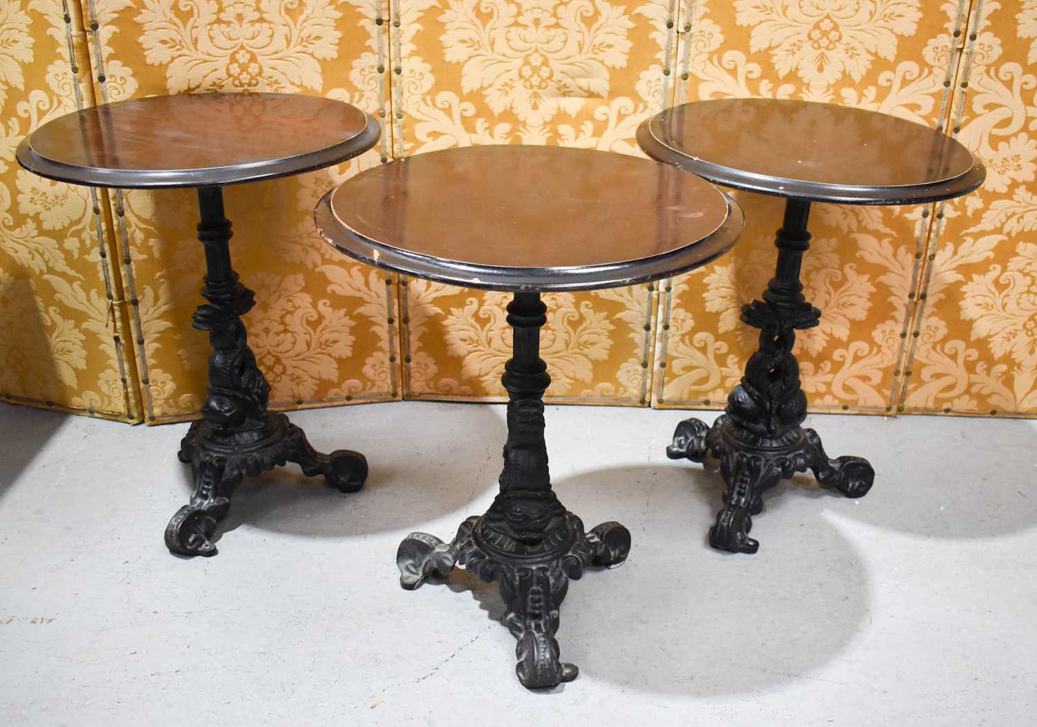 Lot 447 - Three cast iron bar tables with circular