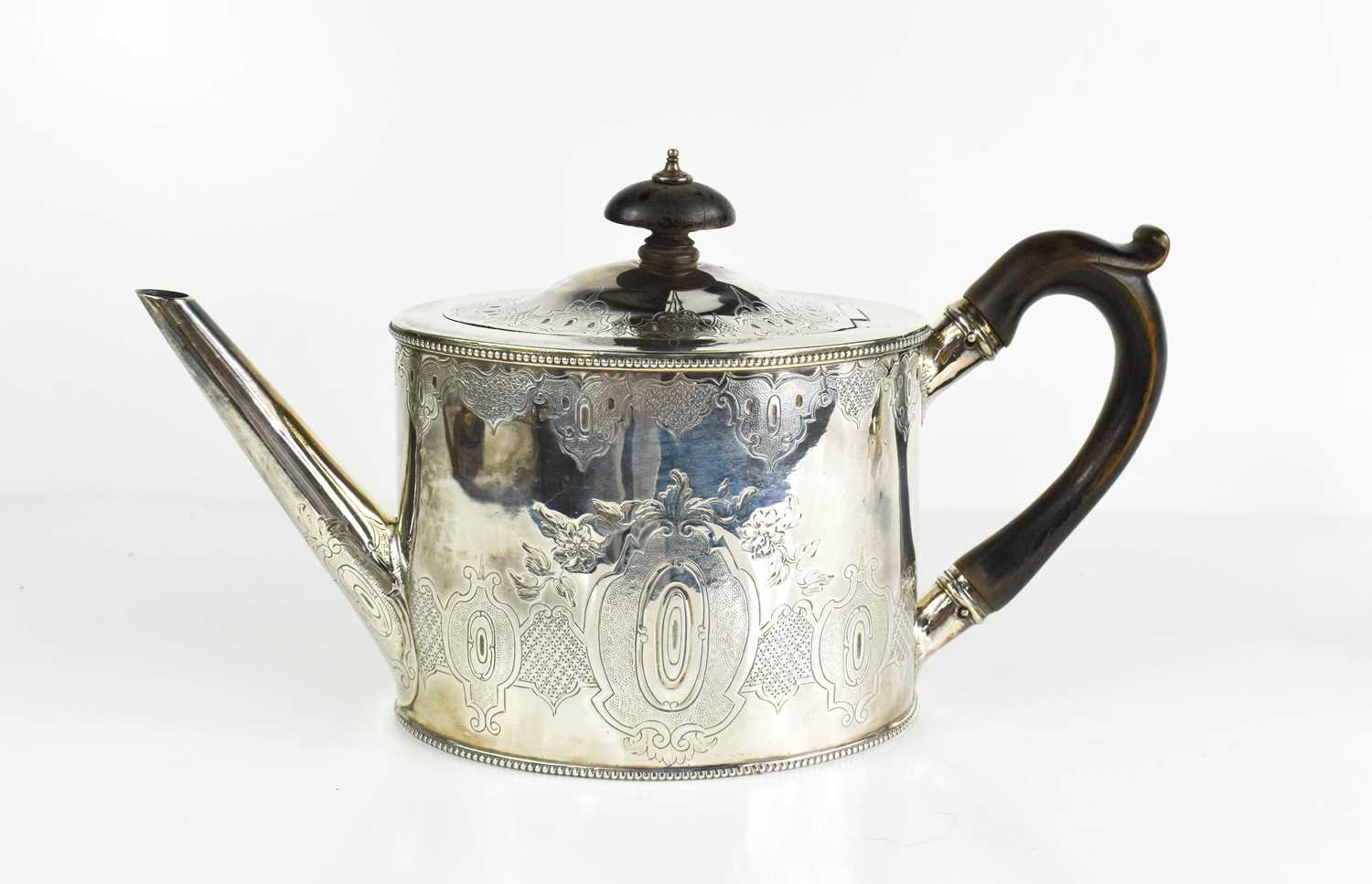 Lot 135 - A silver Edwardian tea pot, engraved with